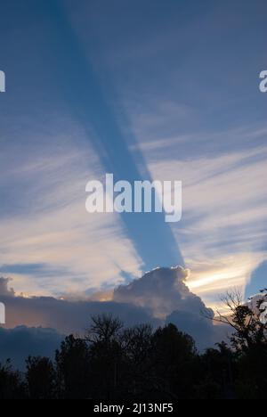 Sunset with clouds and shadows with partially clear sky, shadows cast ...