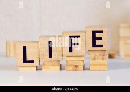 wooden cube whit the inscription Life, with on background. Safe life ...