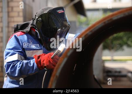 Male welder works. Welding joint of large diameter pipe. High pressure ...