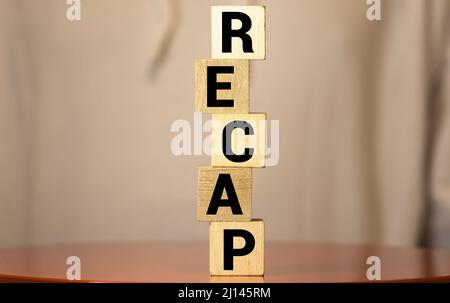 Recap word from wooden blocks on desk Stock Photo - Alamy