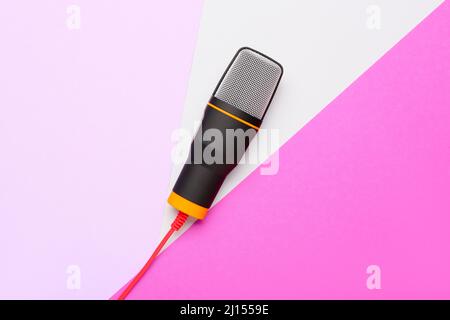New modern microphone on color background Stock Photo - Alamy