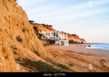 Beautiful landscape of Falesia Beach with high red and orange cliffs in ...