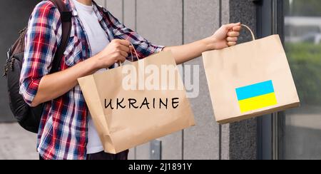 A man holds a box of aid for Ukrainian refugees and poor citizens who ...