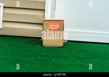 A package outside a residential door with a fragile, handle with care ...