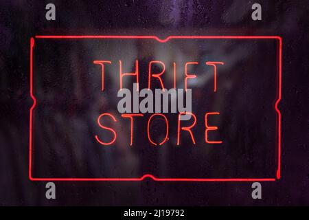 Vintage Neon Thrift Store Sign in Rainy Window Stock Photo - Alamy