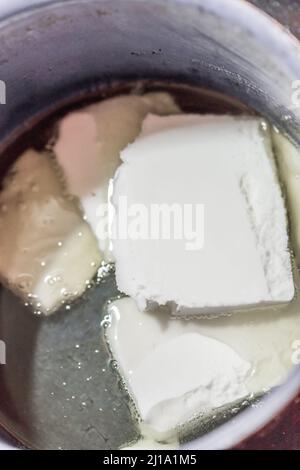 Lard fat in a pot is just melted and dissolves and becomes liquid in a ...