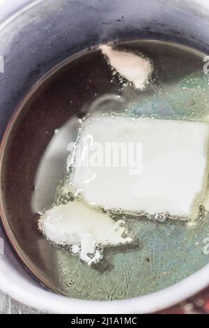Lard fat in a pot is just melted and dissolves and becomes liquid in a ...
