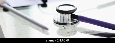 Stethoscope and stylus lying on digital tablet with electrocardiogram ...