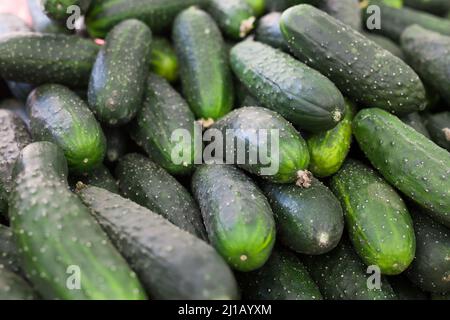 cucumbers on market counter in wicker basket Stock Photo - Alamy