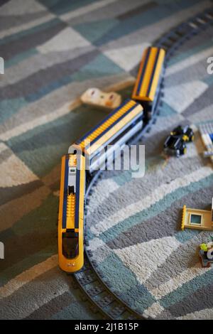 Plastic Lego brand electric toy train and track on a carpet floor Stock ...