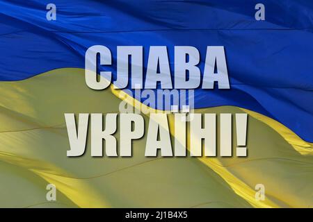 slogan Glory to Ukraine in Ukrainian on waved national flag Stock Photo ...