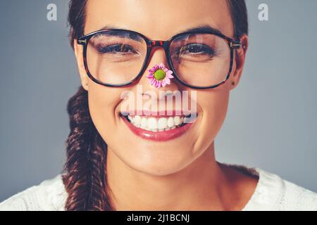 Happiness blooms from within. Shot of a beautiful young woman relaxing ...