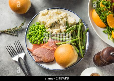Homemade Easter Ham Dinner with Pototoes Beans and Peas Stock Photo - Alamy
