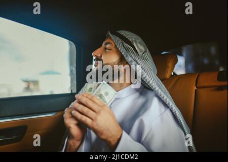 Saudi arab man holding car keys and smiling isolated on white ...