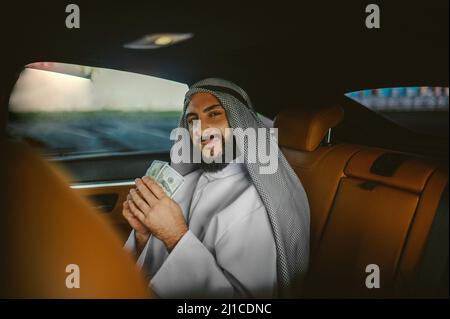 Saudi arab man holding car keys and smiling isolated on white ...