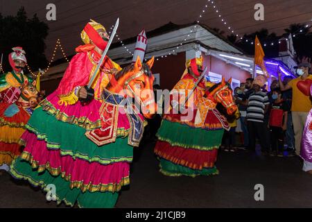 Group of men dressed as horse mounted soldiers, in colourful attire ...