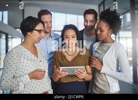 Giving them a little preview. a group of businesspeople looking over a ...