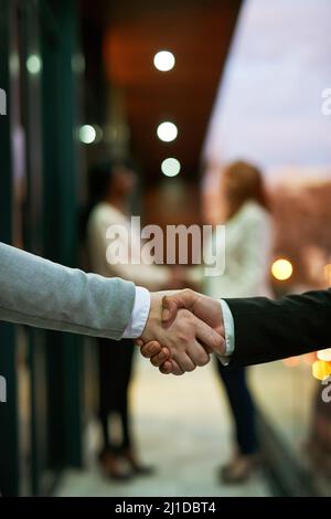 Building partnerships. businesspeople shaking hands in a modern office ...