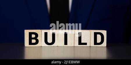 Man made word build with wood blocks Stock Photo - Alamy