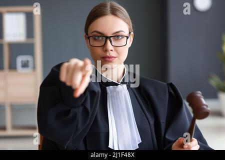 Young female judge pointing at viewer in courtroom Stock Photo - Alamy