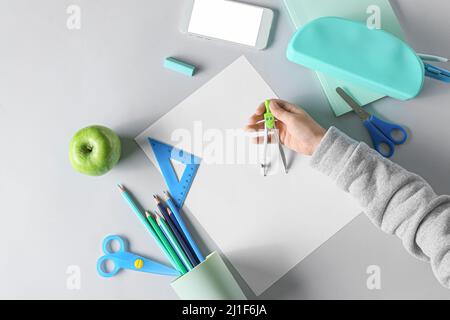 Child's hand with mobile phone and different stationery on pink ...