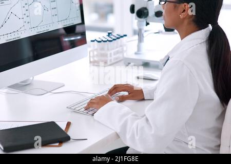Shes a genius behind the computer. Cropped shot of an unrecognizable ...