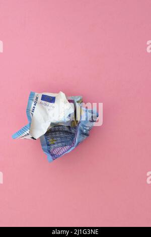 Crumpled 20 Euro banknote on antique pink background and lettering of ...
