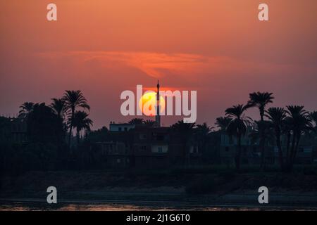 Sun setting behind minaret on the Nile Stock Photo - Alamy