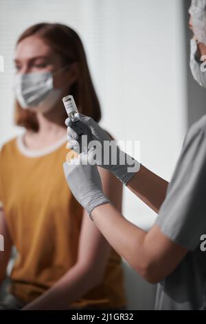 Doctor wearing medical gloves filling the test tube against coronavirus ...