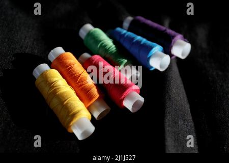 Closeup of thread reels on a black background Stock Photo - Alamy