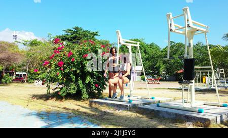 A distant view of two females working out at the beach in Koh Samui ...