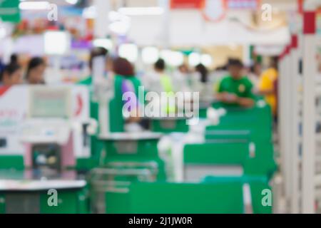 supermarket checkout payment terminal with customers blurred background ...