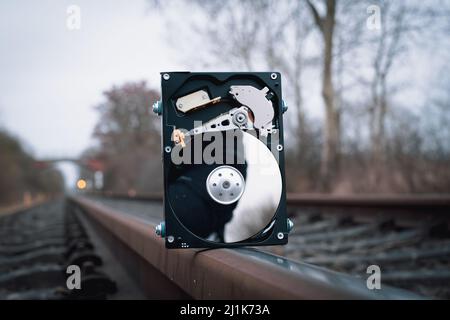 a hard disk stands on the rails of the railroad Stock Photo - Alamy