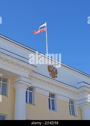 State symbols, flag and coat of arms of Ukraine on sky background ...