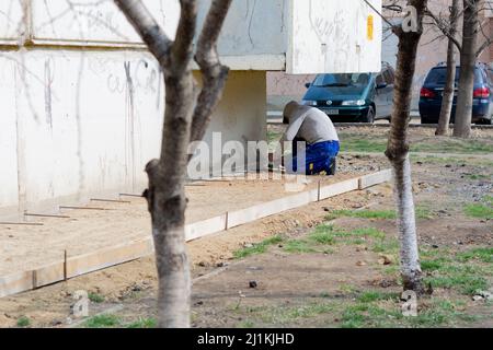 Foundation blind area preparing. An unknown worker of European ...
