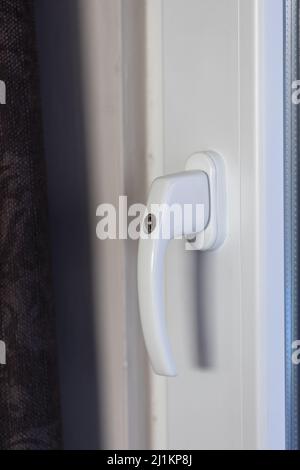 A vertical photo of a white door handle Stock Photo - Alamy