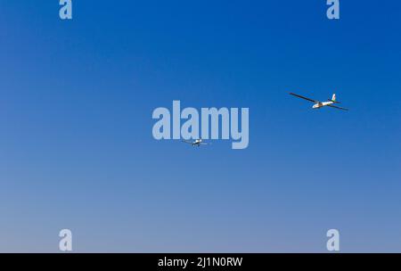 Ultra light, cessna plane drag on glider with prolonge rope on blue sky ...