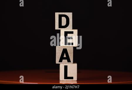 DEAL word on cube blocks on blue background Stock Photo - Alamy