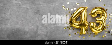 Golden number forty three 43 made of inflatable balloon with ribbon on ...