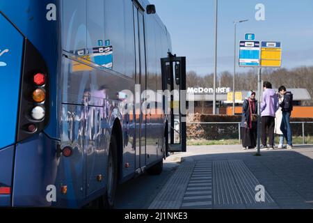 Side view of a blue Qliner bus at the station of the dutch village of ...