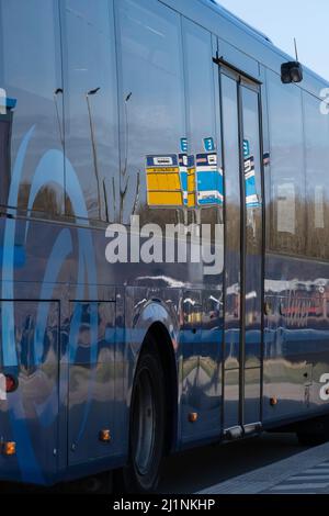 Side view of a blue Qliner bus at the station of the dutch village of ...