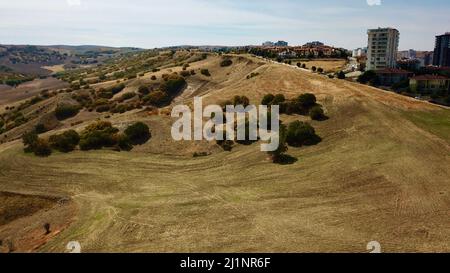 Rural settlement and land. Empty farmland and cityscape in the distance ...