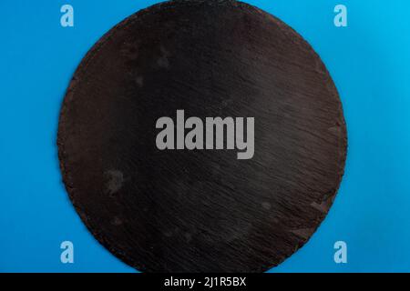 Empty black round slate serving board on white background with rustic ...