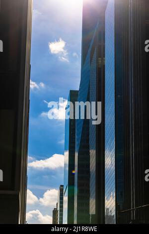 The sun shines among rows of high-rise buildings in Midtown Manhattan ...