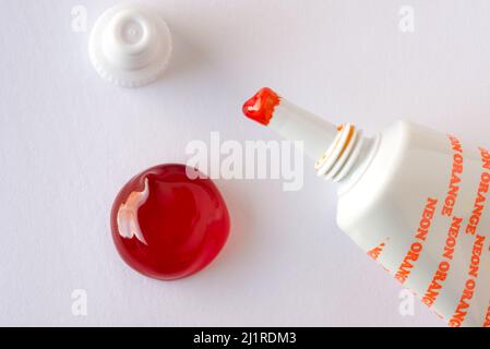 Tube with orange food coloring isolated on white Stock Photo - Alamy