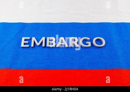 the word embargo laid with silver metal letters on russian tricolor ...