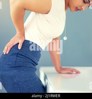 Ive been working for too long. a young businesswoman experiencing a ...