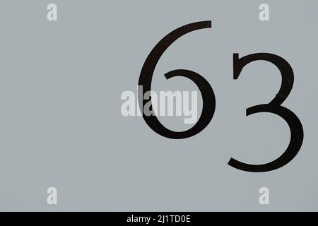 house number 63 painted at the grey wall Stock Photo - Alamy