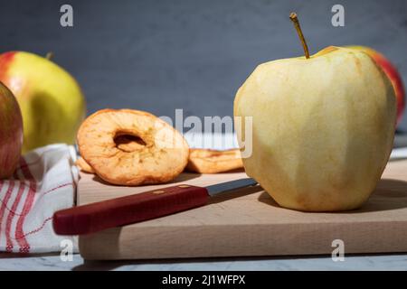 Peeled ripe red apple on a kitchen countertop, side view. Background ...