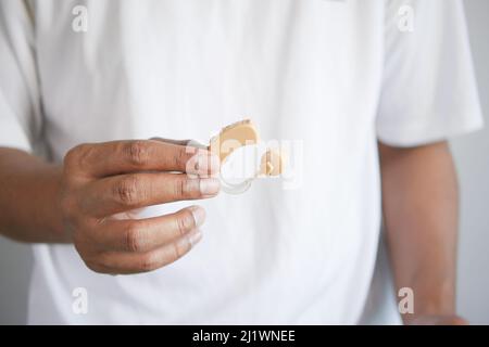 Hearing aid concept, a young man with hearing problems Stock Photo - Alamy